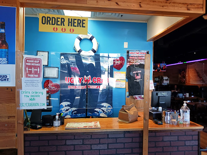 "Order Here" sign hanging above a nautical-themed counter—the maritime equivalent of "Open Sesame" for seafood treasures.