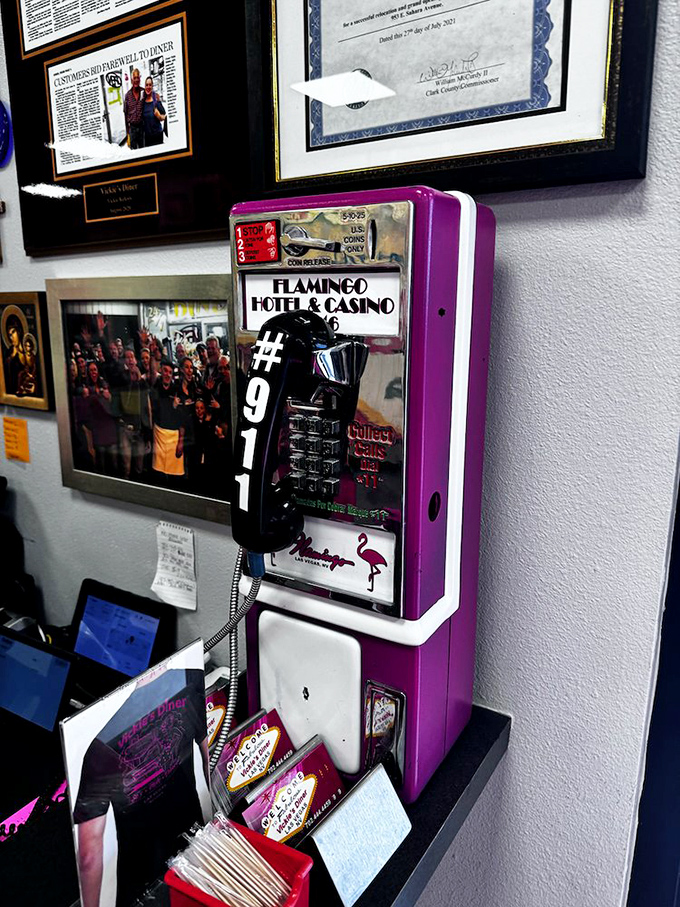 This vintage Flamingo Hotel phone has heard more Vegas secrets than a casino pit boss, now retired to the wall of Vickie's like a badge of honor.