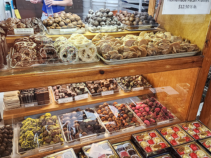 Chocolate's greatest hits album on display. This multi-tiered showcase features everything from truffles to chocolate-covered delicacies in perfect harmony.