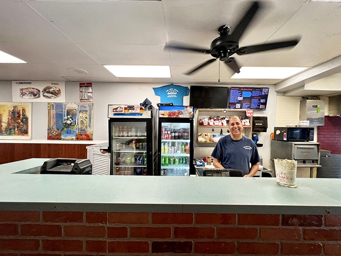 Behind every great sandwich shop is someone who knows exactly what you need before you order it. That knowing smile says it all.
