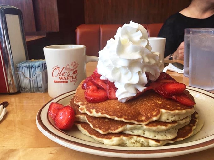 Pancakes stacked higher than my hopes for retirement, crowned with strawberries and whipped cream. Breakfast royalty has arrived.
