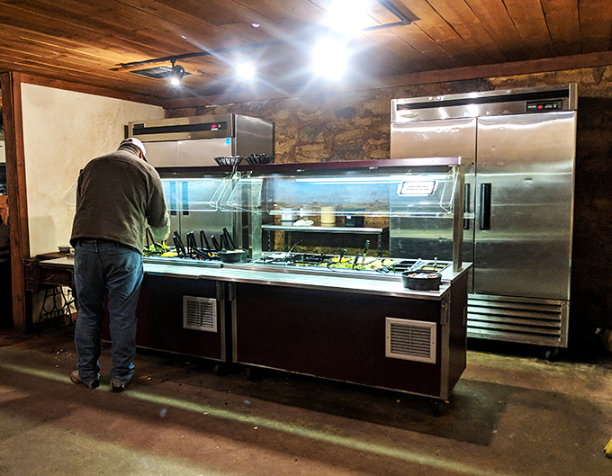 A gentleman surveys the salad bar&mdash;not because he's particularly excited about lettuce, but because it's the traditional first act before the beef takes center stage.