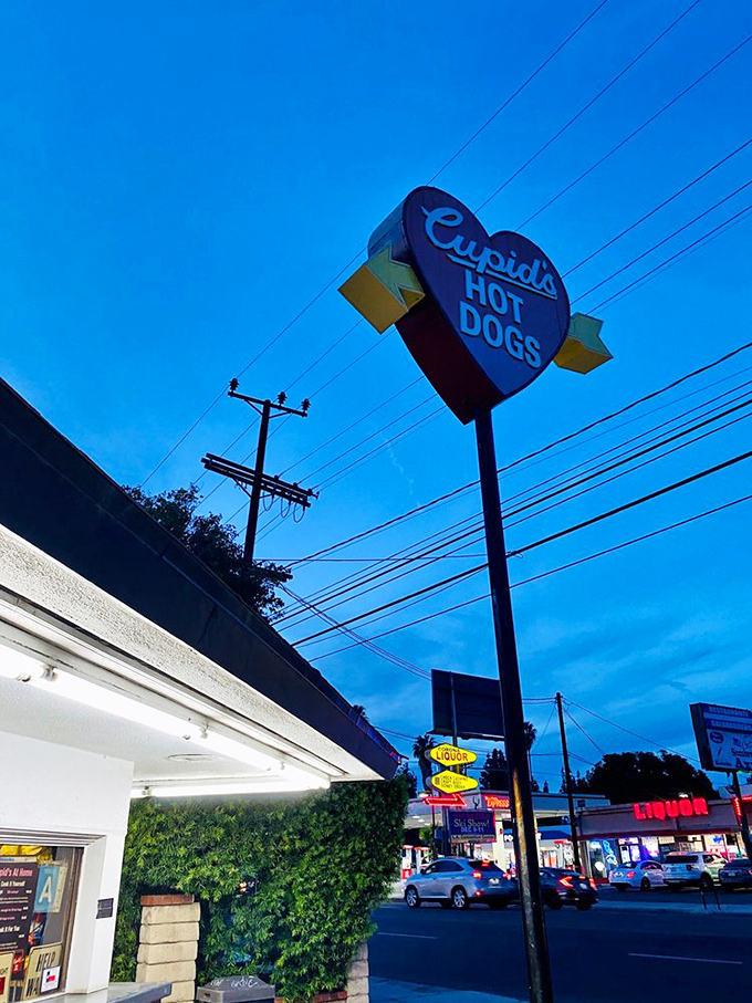 That heart-shaped sign against the twilight sky &ndash; a beacon of hope for the hungry and a landmark for the locals.
