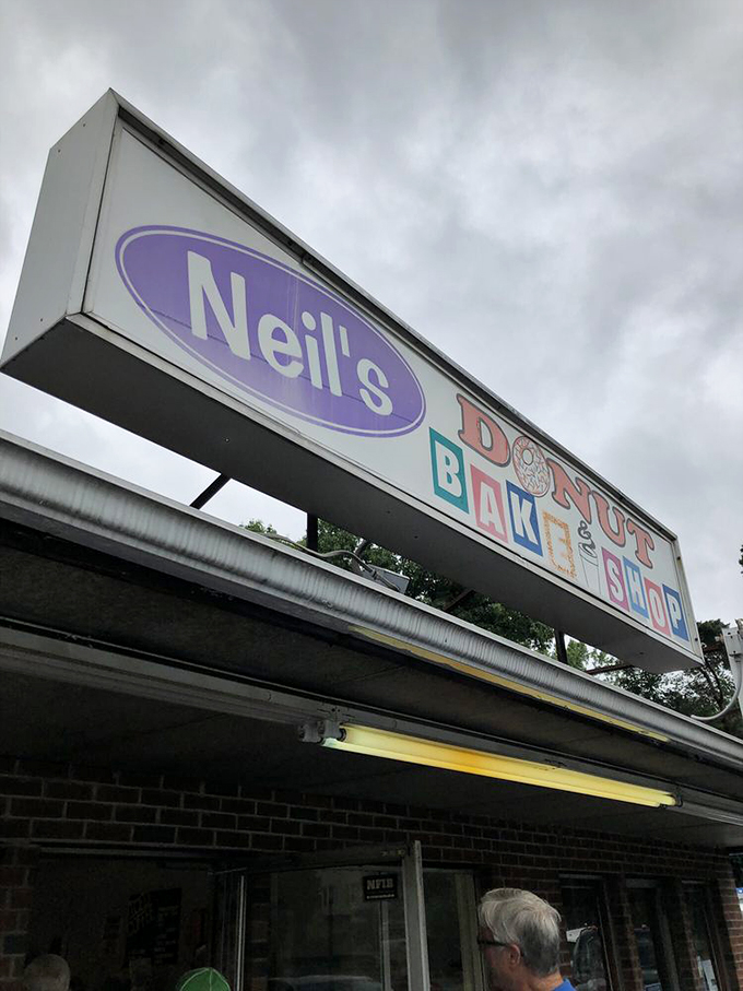 The purple and blue sign beckons like a lighthouse for the sugar-deprived. "Hot, Fresh, Good" isn't just a slogan&mdash;it's a promise.