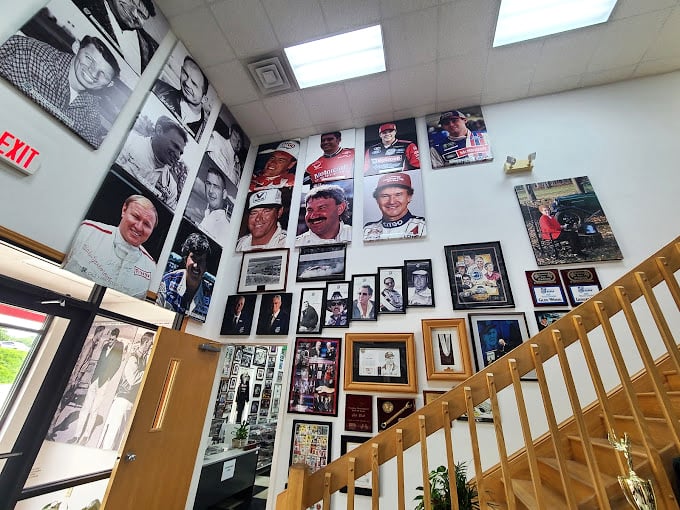 The stairway to NASCAR heaven is lined with faces who changed motorsport forever. This hall of fame wall documents seven decades of speed merchants.