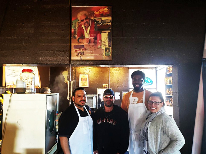 The staff poster shows the faces behind the flavor. That photo of Guy Fieri watching from above is BBQ's version of the Mona Lisa.