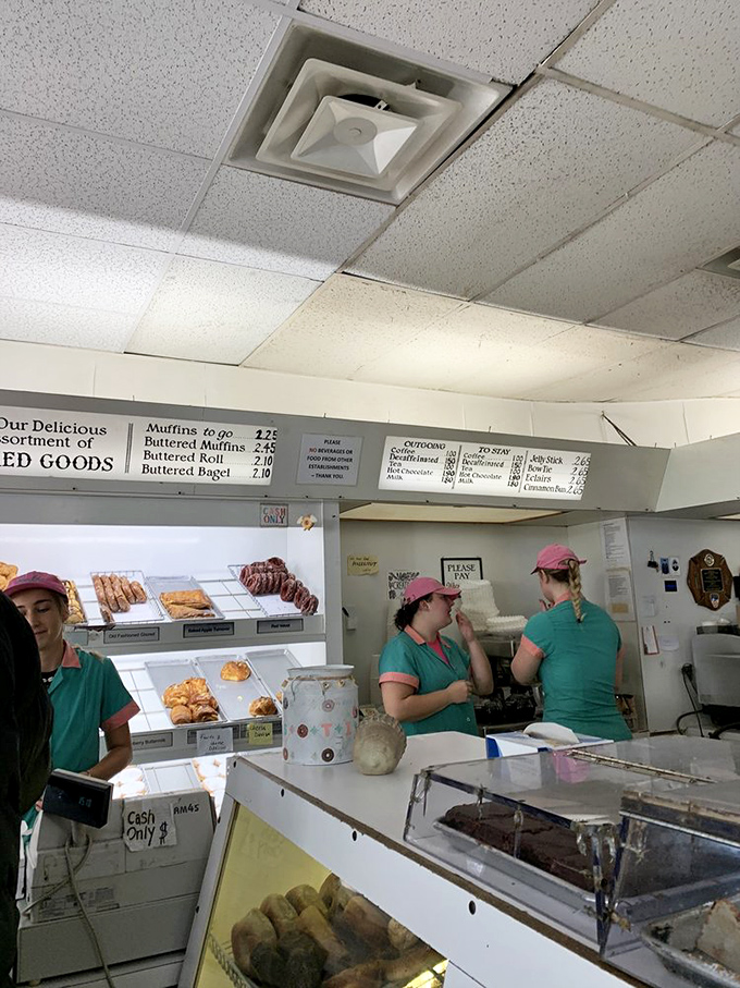 Pink-capped staff work with ballet-like precision, their choreography perfected through thousands of morning rushes.