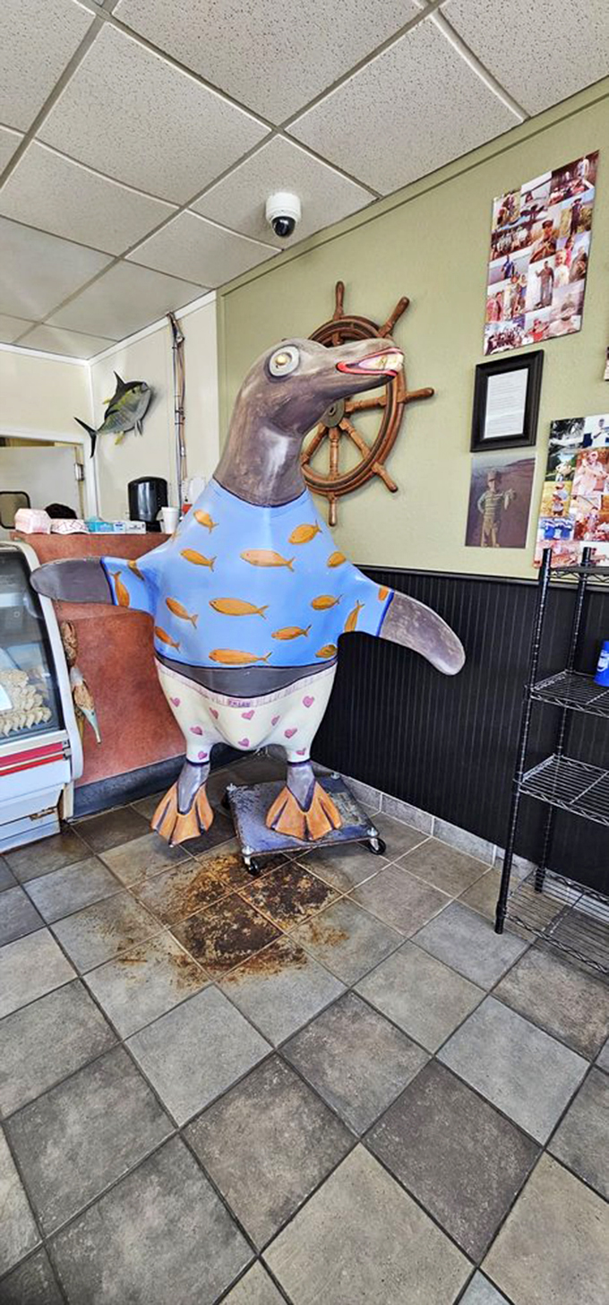 Meet the unofficial greeter&mdash;a penguin statue wearing a fish-patterned shirt because even the d&eacute;cor has a sense of humor here.