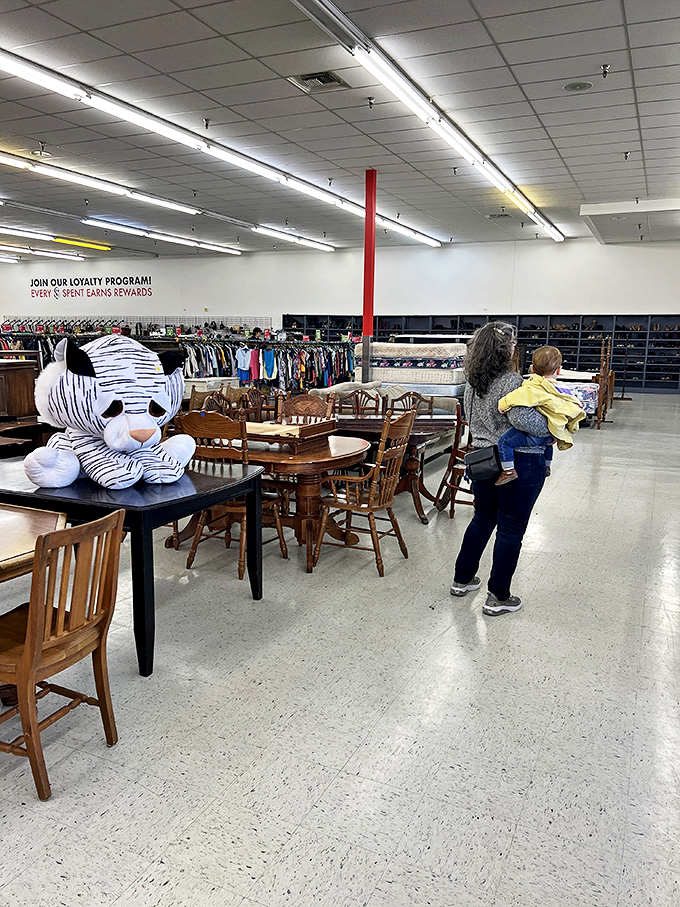 Dining sets await new family gatherings, while a giant stuffed tiger supervises the proceedings with plush authority.