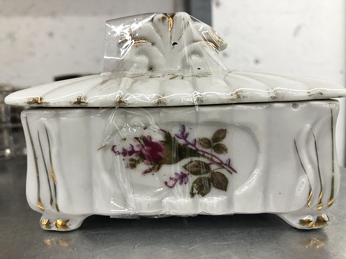 A vintage trinket box that whispers tales of bygone vanities. Someone once treasured this floral keeper of secrets&mdash;perhaps you'll be next.