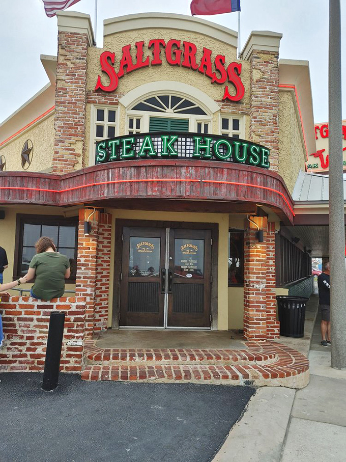 Saltgrass Galveston combines Gulf views with Gulf-raised beef. That brick and stucco exterior houses coastal steak magic.