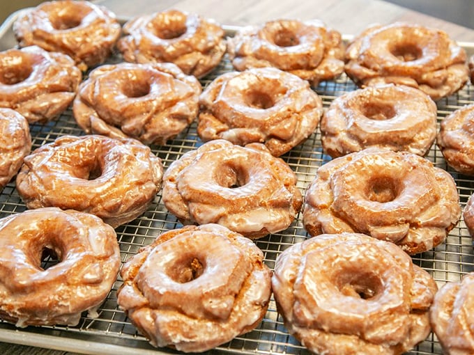 Old-fashioned donuts with that signature crackle &ndash; lined up like soldiers ready for their glaze bath.