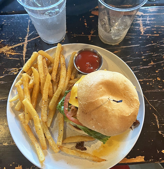 This isn't just a burger &ndash; it's architecture, engineering, and art all stacked between a brioche bun with crispy fries standing guard.