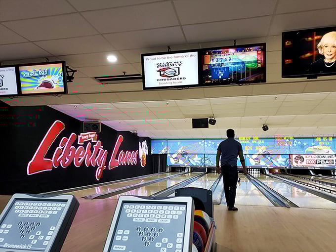 The Liberty Lanes logo glows like a beacon of analog fun in a digital world&mdash;promising an evening where the only notifications you'll check are your scores.