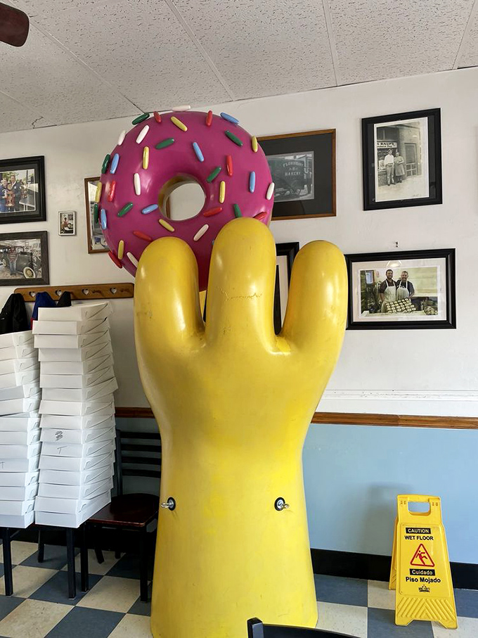Late night at Old Town Donuts – where the illuminated yellow hand beckons night owls and early birds alike to sugary salvation.