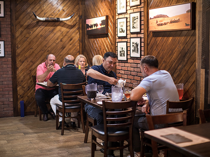 Where modern design meets old-world hospitality. The wood-paneled interior with glass ceiling panels creates an atmosphere that welcomes you like a warm handshake.