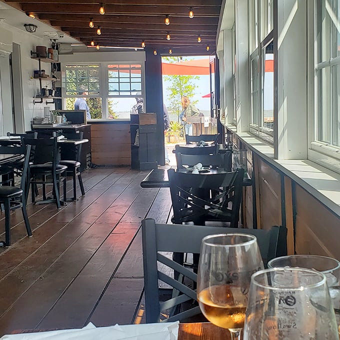 Sunlight streams through windows framing water views&mdash;the kind of dining room where memories marinate alongside the daily catch.
