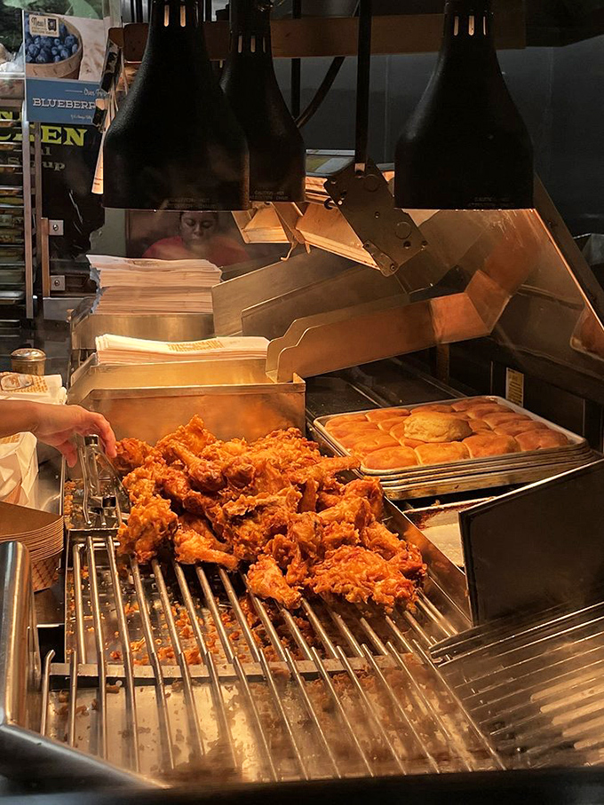 Behind the scenes where magic happens &ndash; fresh chicken getting its golden ticket to flavor town under watchful eyes.