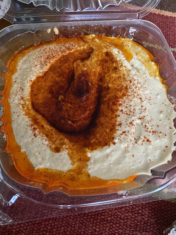 Hummus swirled to perfection with that signature paprika crown &ndash; the kind that makes store-bought versions hang their heads in shame.