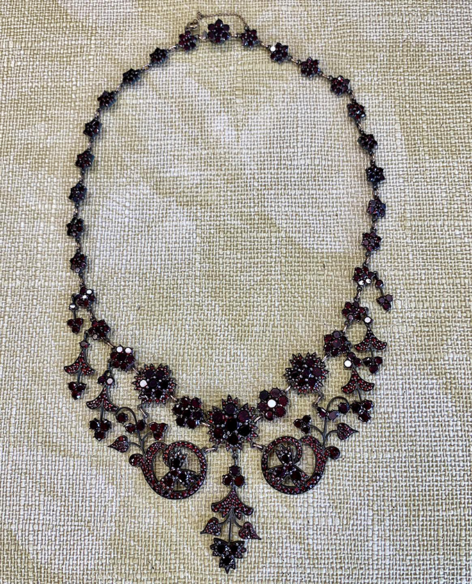Victorian-era craftsmanship shines in this intricate garnet necklace. Jewelry this detailed tells stories spanning generations.