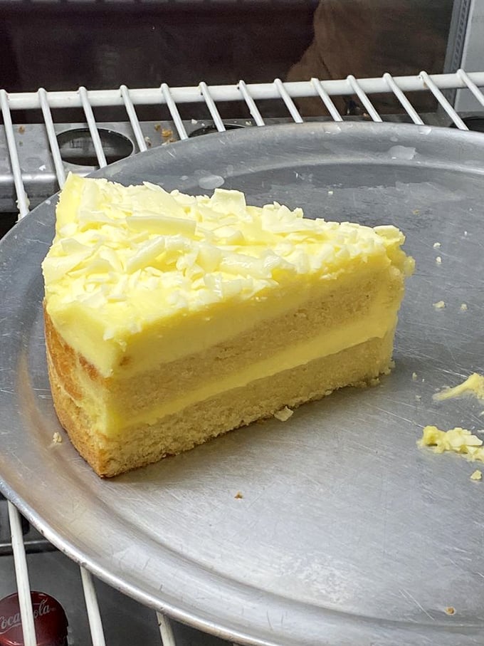 A slice of lemon cake so bright it could cure seasonal affective disorder. Sunshine in dessert form waiting to brighten your day.