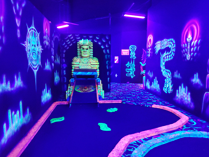 Blacklight mini-golf where everything glows except your score card. Even your white sneakers become part of the entertainment.