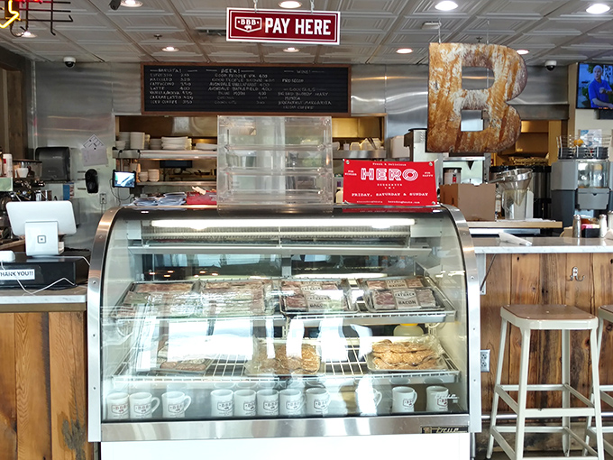 The display case of morning treasures stands ready for inspection. Behind that counter, breakfast dreams become delicious reality.