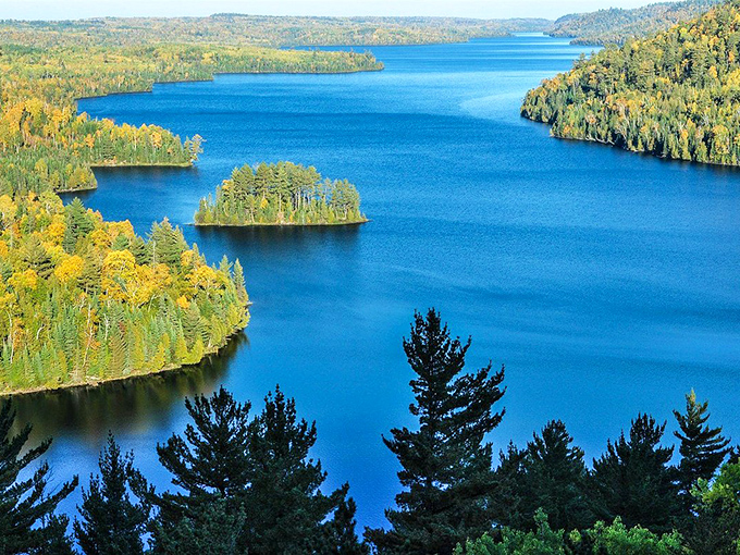 The Boundary Waters spread their blue-jeweled splendor before you, a wilderness playground that makes you feel simultaneously tiny and infinite.