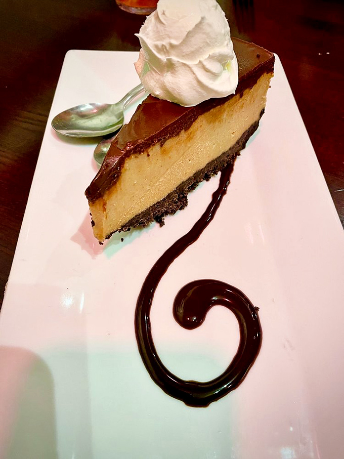 A slice of peanut butter pie with that artistic chocolate swirl&mdash;proof that someone in the kitchen understands the importance of a proper finale.