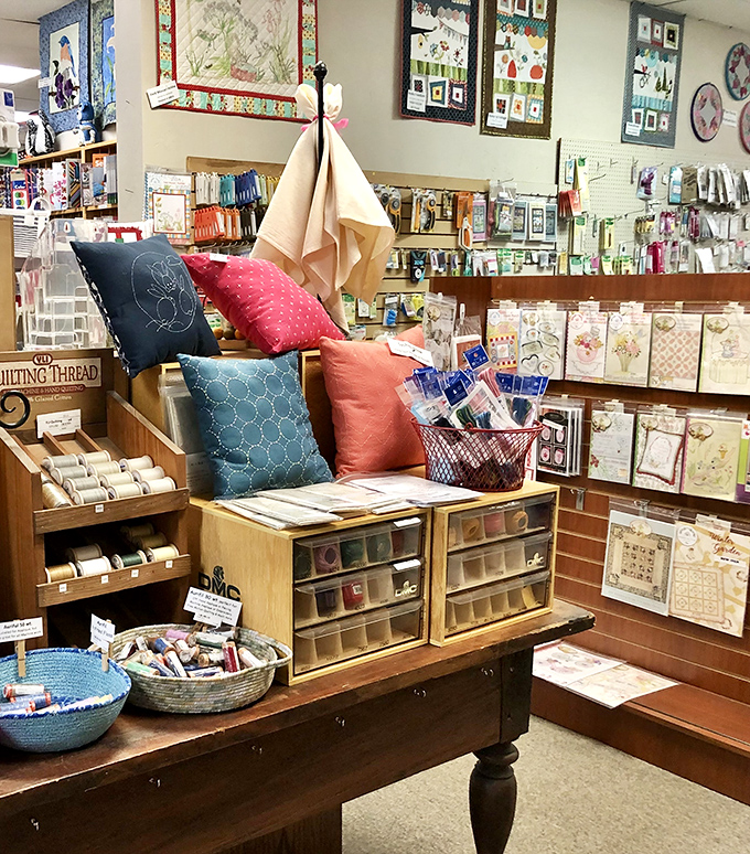 Quilting accessories that combine function with beauty. Those pillows aren't just decorative&mdash;they're advertisements for the artform itself.