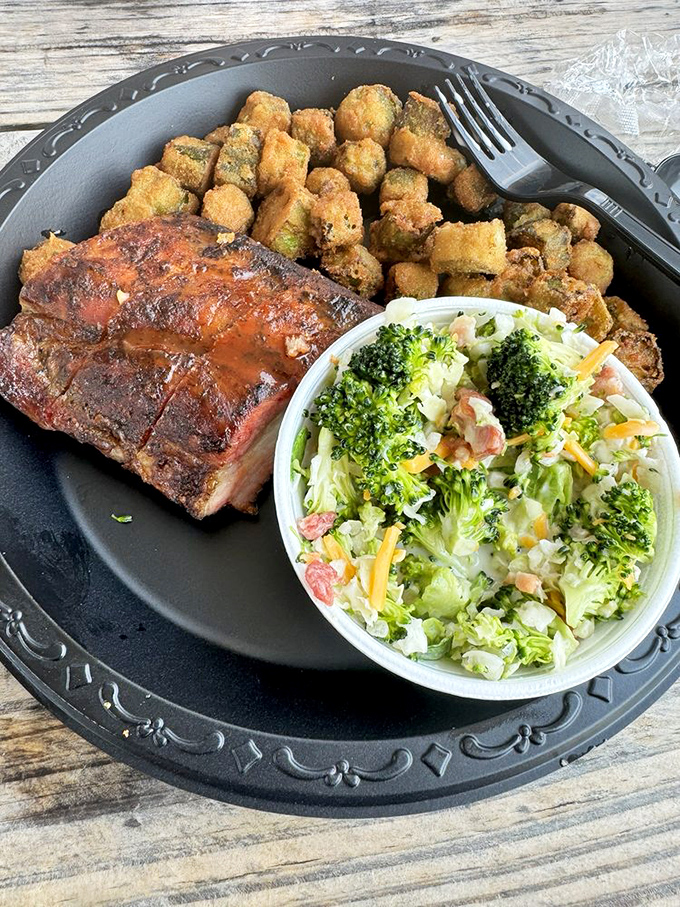 The barbecue trifecta: smoky ribs, golden-fried okra, and a broccoli salad that somehow makes eating vegetables feel indulgent.