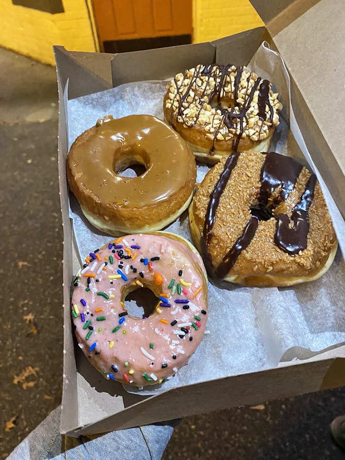 That salted caramel glaze catches the light like amber. Four distinct personalities waiting to be the highlight of someone's morning commute.