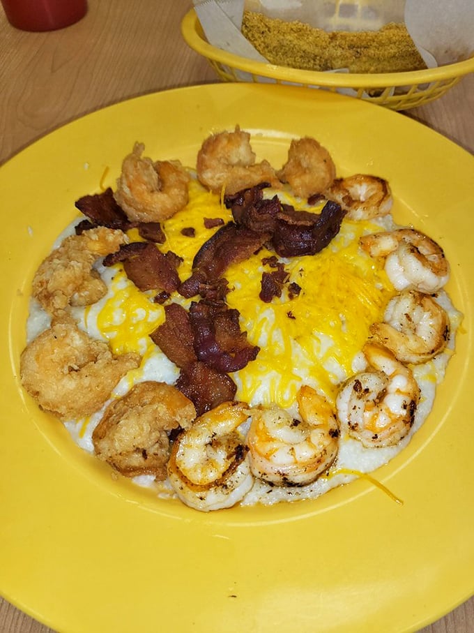 Shrimp and grits elevated to an art form, with bacon confetti celebrating the marriage of land and sea atop a creamy canvas.