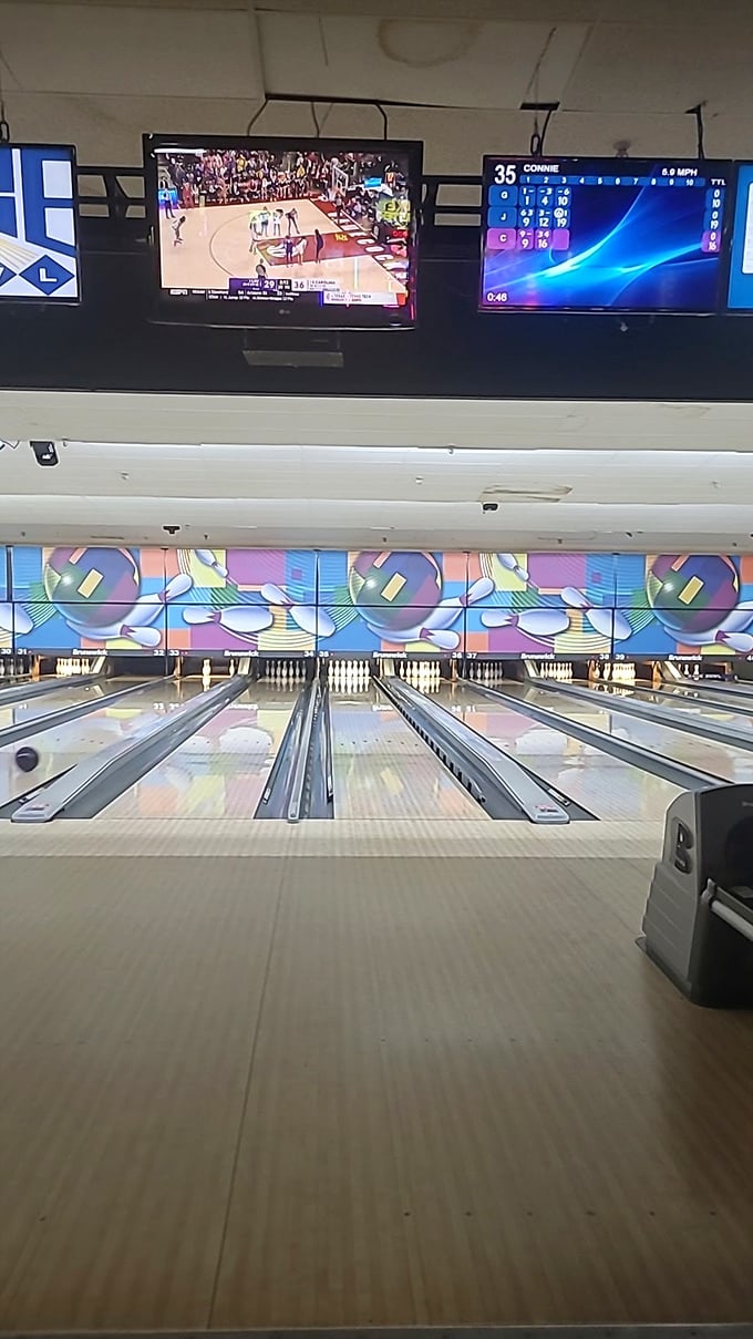 The view from behind the pins&mdash;where every approach tells a story and the carpet pattern has witnessed decades of victory dances.