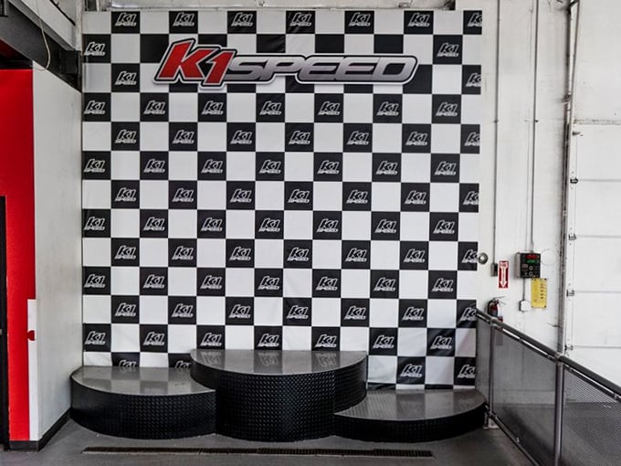 Victory has its place—literally. This podium has witnessed more adult jumping than a Black Friday sale at Best Buy.