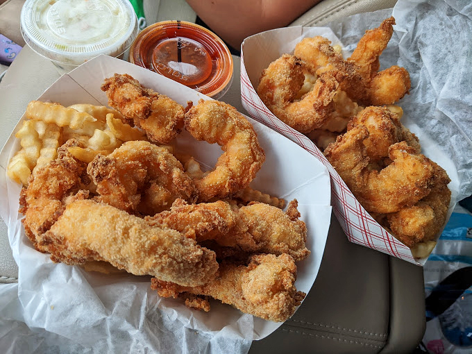 Food worth the drive: two containers of golden fried shrimp with tartar and cocktail sauce standing by for dunking duty.