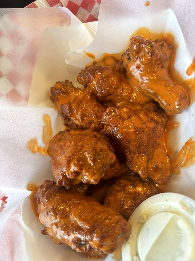 Wings that deliver that perfect balance of crispy exterior and juicy interior, bathed in sauce that demands finger-licking despite public decorum.