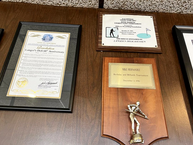 The wall of accolades tells a story: decades of excellence recognized by everyone from city officials to devoted regulars.