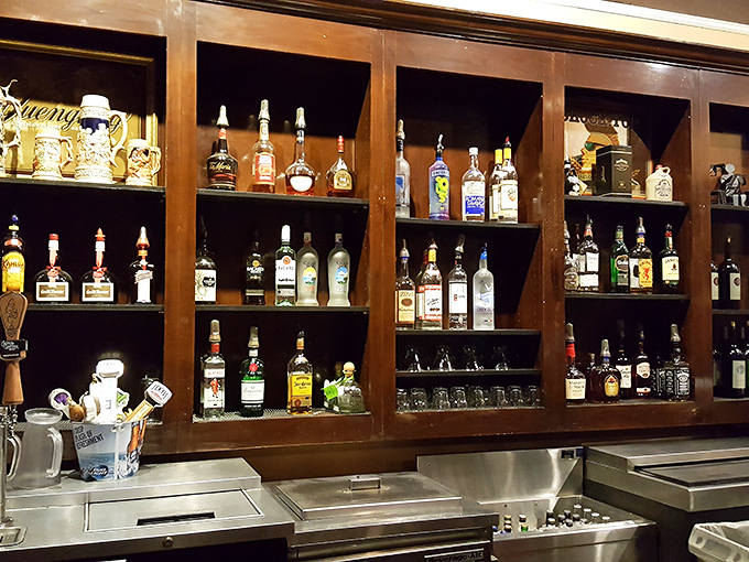 Behind the bar, bottles stand at attention like soldiers guarding liquid treasures. This isn't just a drink selection&mdash;it's a cabinet of possibilities.