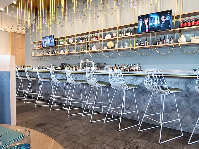 The bar at The Drake isn't just where drinks are made; it's where strangers become friends and the workday dissolves into evening bliss.