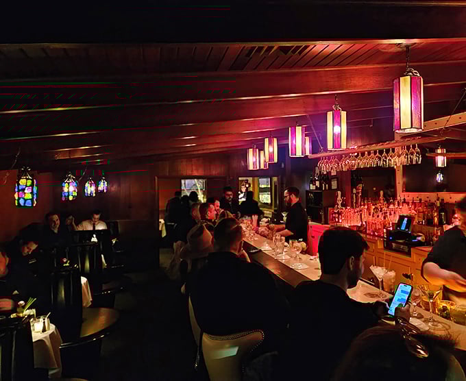 Inside this wood-paneled sanctuary, cocktails are crafted with care while patrons debate the merits of ribeye versus strip.