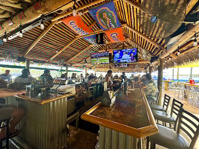 Thatched roof, sports on TV, and a bar that stretches toward the water. This is where "I'll just have one drink" becomes a delightful lie.