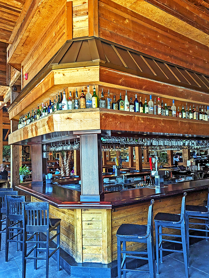 The bar area isn't just serving drinks; it's offering liquid therapy with a side of Southern hospitality in a wood-framed sanctuary.