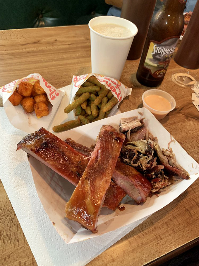Sweet tots and fried green beans flanking ribs that glisten like they've been polished. This is what happens when side dishes refuse to be overshadowed.