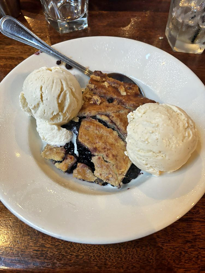 Dessert here isn't an afterthought&mdash;it's the final movement in a culinary symphony where this warm berry masterpiece with dual scoops plays the delicious finale.