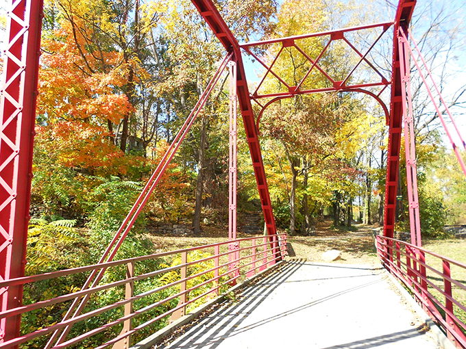 The iconic red bridge offers passage through a tunnel of autumn colors&mdash;infrastructure transformed into an Instagram moment by Mother Nature.