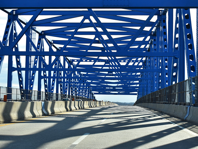 The striking blue of the St. Georges Bridge creates a geometric masterpiece against the sky. Engineering and art having a beautiful conversation.