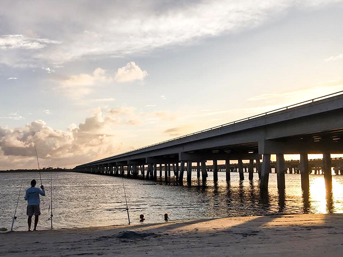 The bridge at sunset creates the perfect silhouette for fishing stories that grow taller as the evening shadows lengthen.