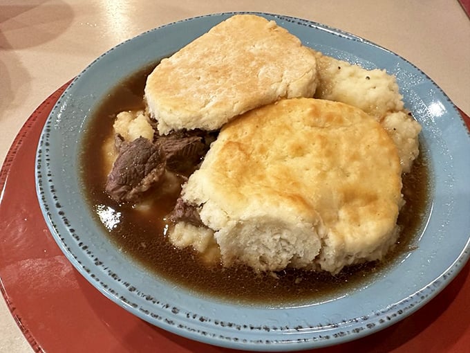 Biscuits floating like golden islands in a sea of savory gravy. This dish doesn't just feed your hunger&mdash;it hugs your soul from the inside.