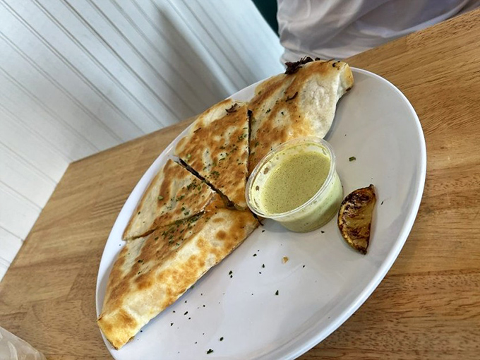 The quesadilla&mdash;reinvented as a delivery system for smoky brisket. That charred exterior promises the perfect textural contrast to melty interior goodness.